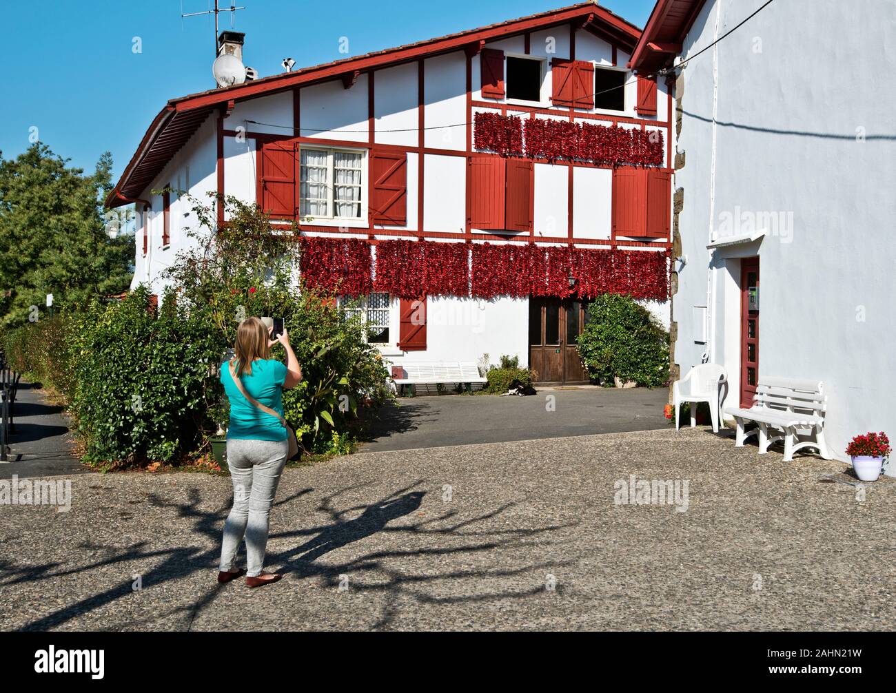Women take photo with her Smartphone of traditional Basque house with ...