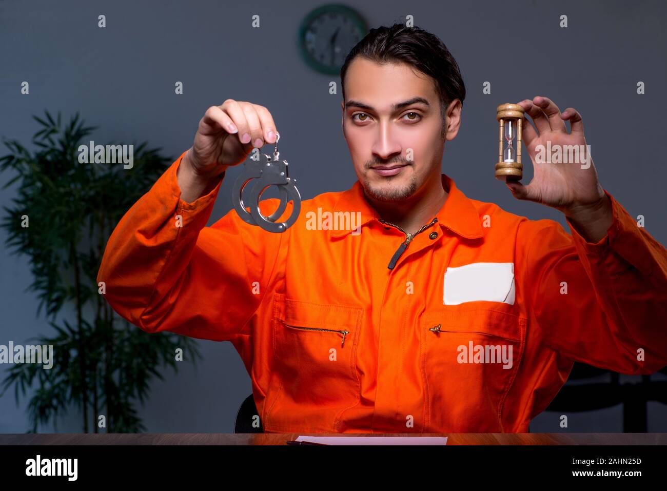 The young convict man sitting in dark room Stock Photo - Alamy