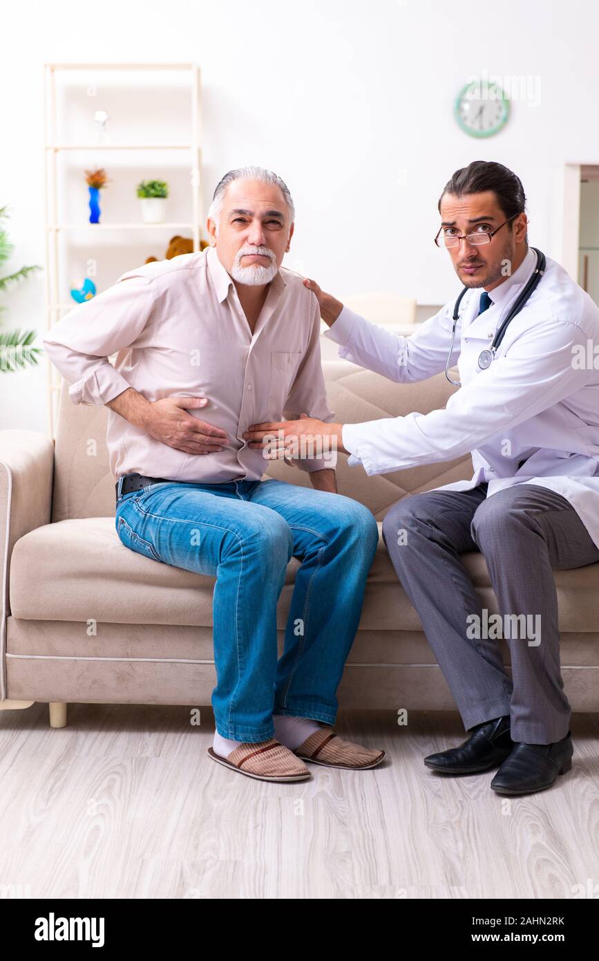 Doctor touching stomach mature patient hi-res stock photography and ...