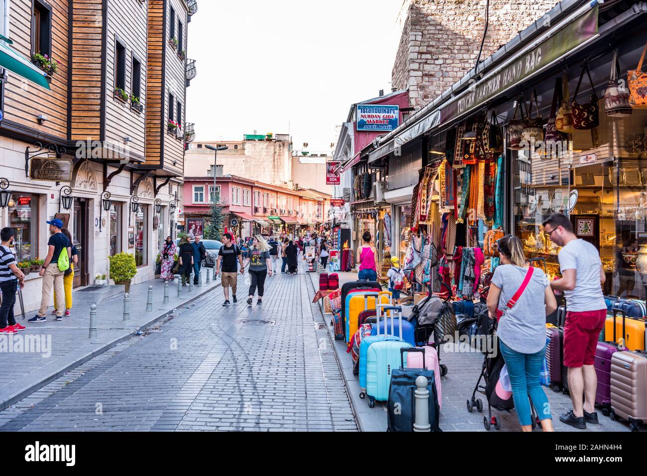 Tourists walk at street in European side with colorful souvenir and ...