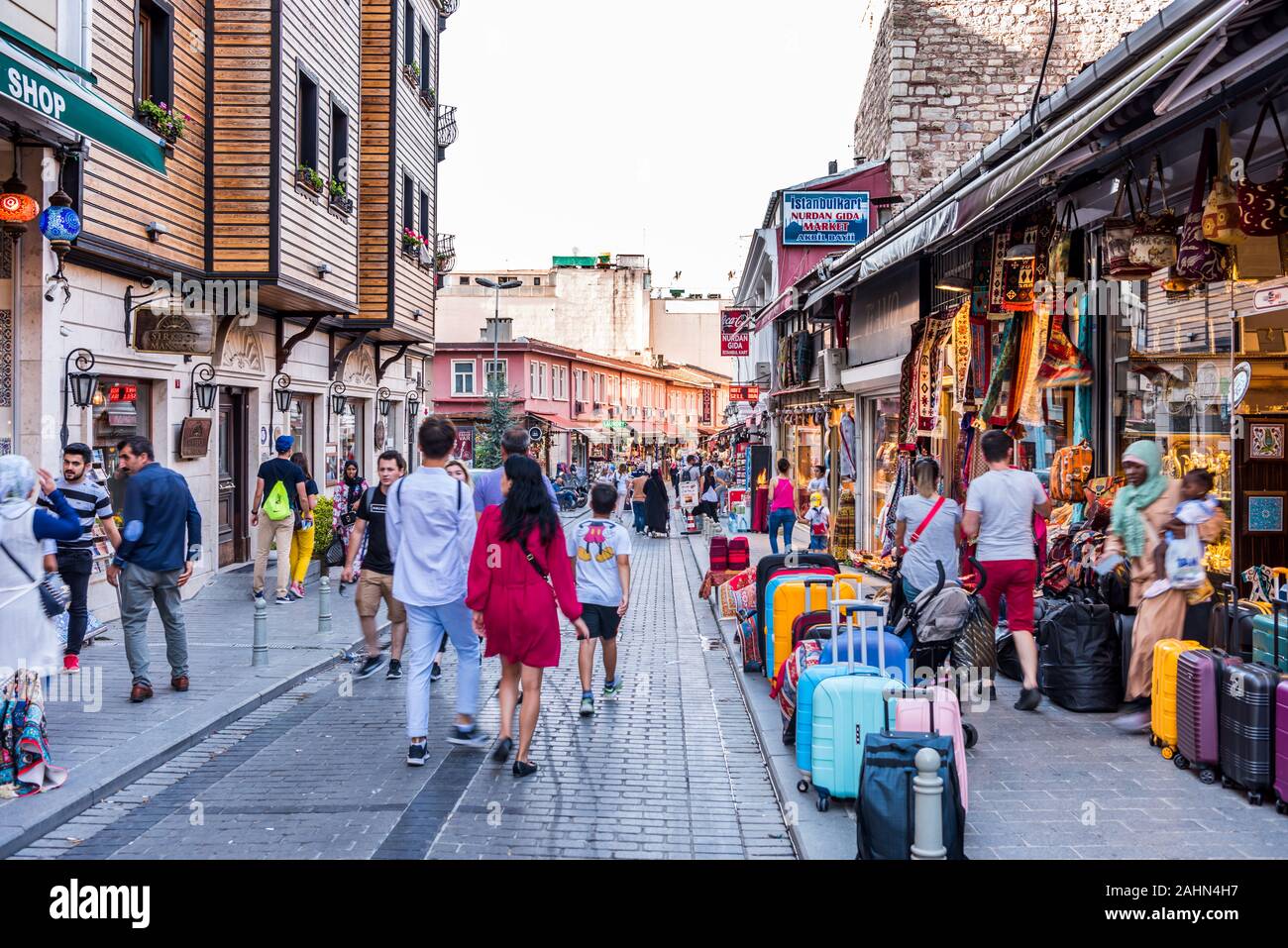 Tourists walk at street in European side with colorful souvenir and ...