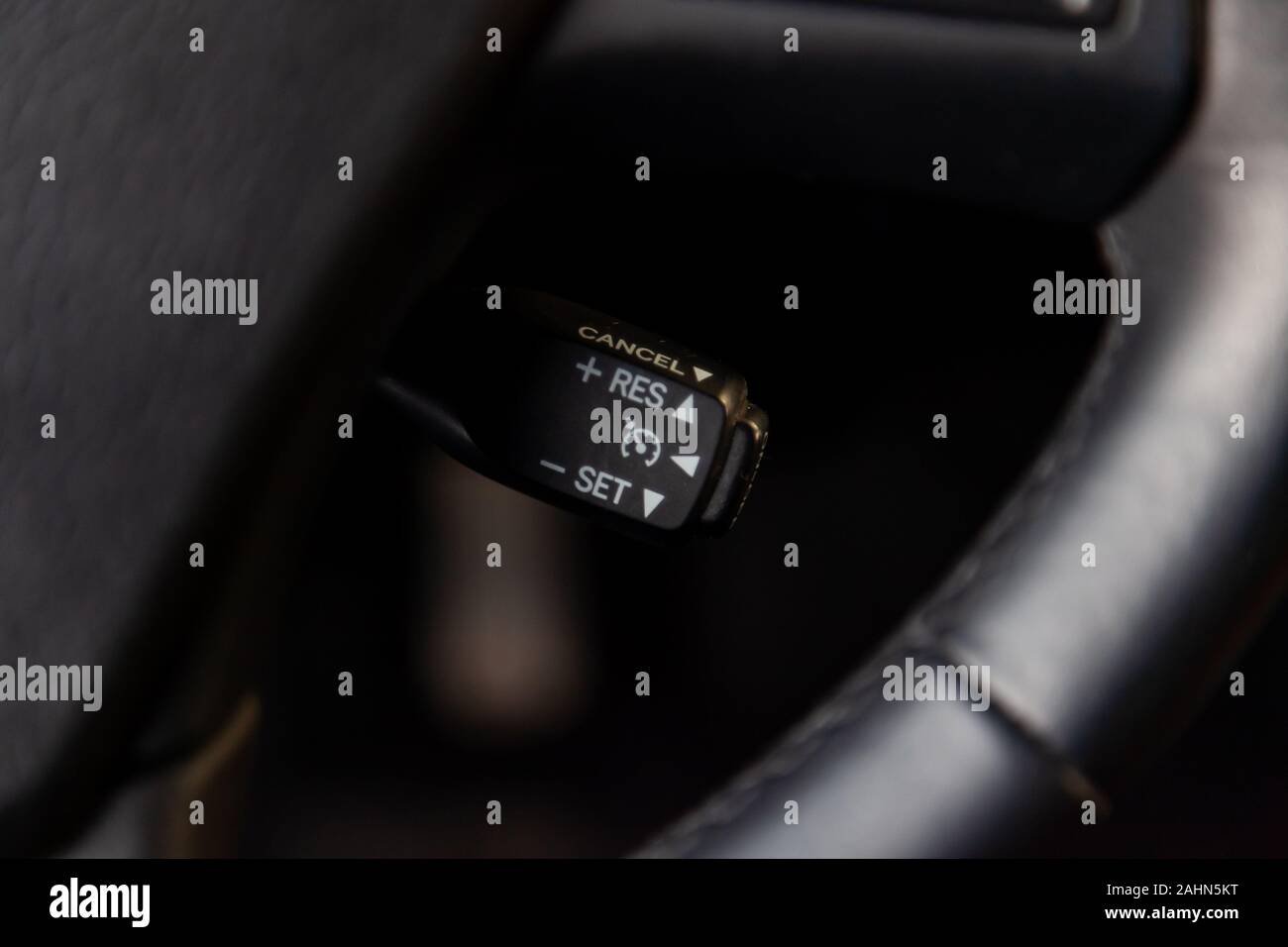 The shift lever to set the automatic cruise control speed inside the ...