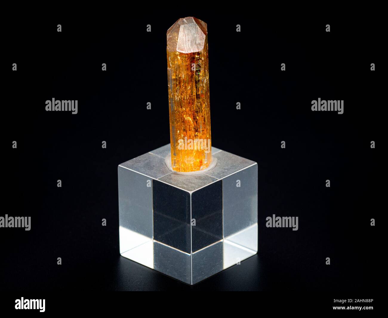 golden imperial topaz mineral on black background Stock Photo - Alamy
