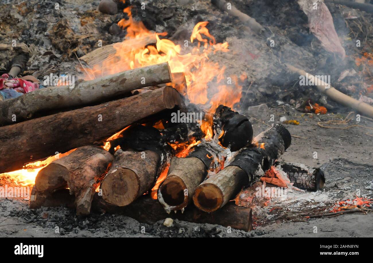 The body of a Hindu person is being cremated in the traditional way and ...
