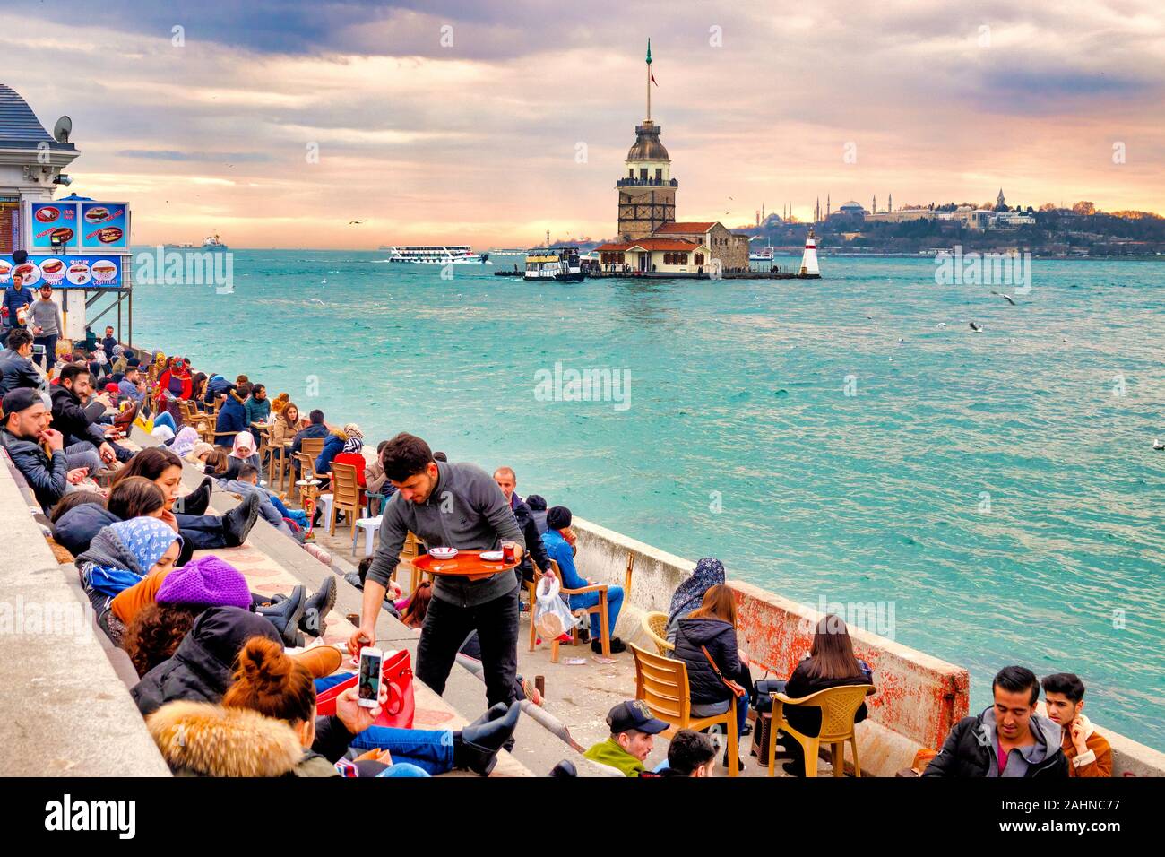People drinking tea on the waterfront in front of the Maiden’s Tower ...