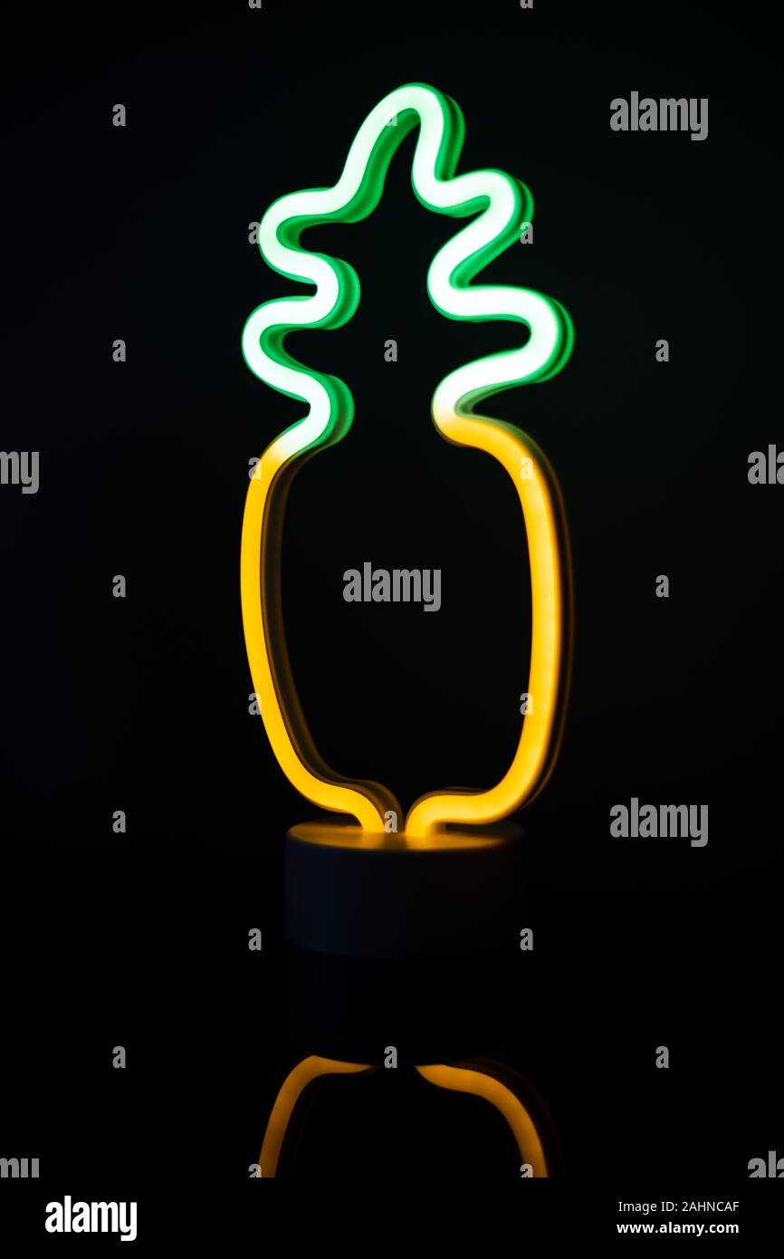 pineapple led neon light in dark room Stock Photo - Alamy