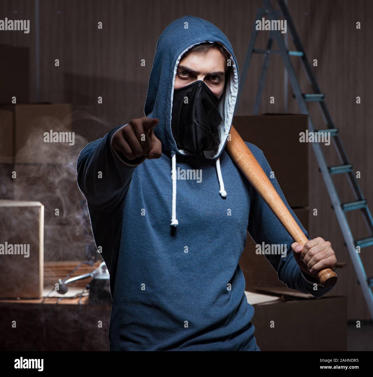 The hooligan with bat in dark room Stock Photo - Alamy