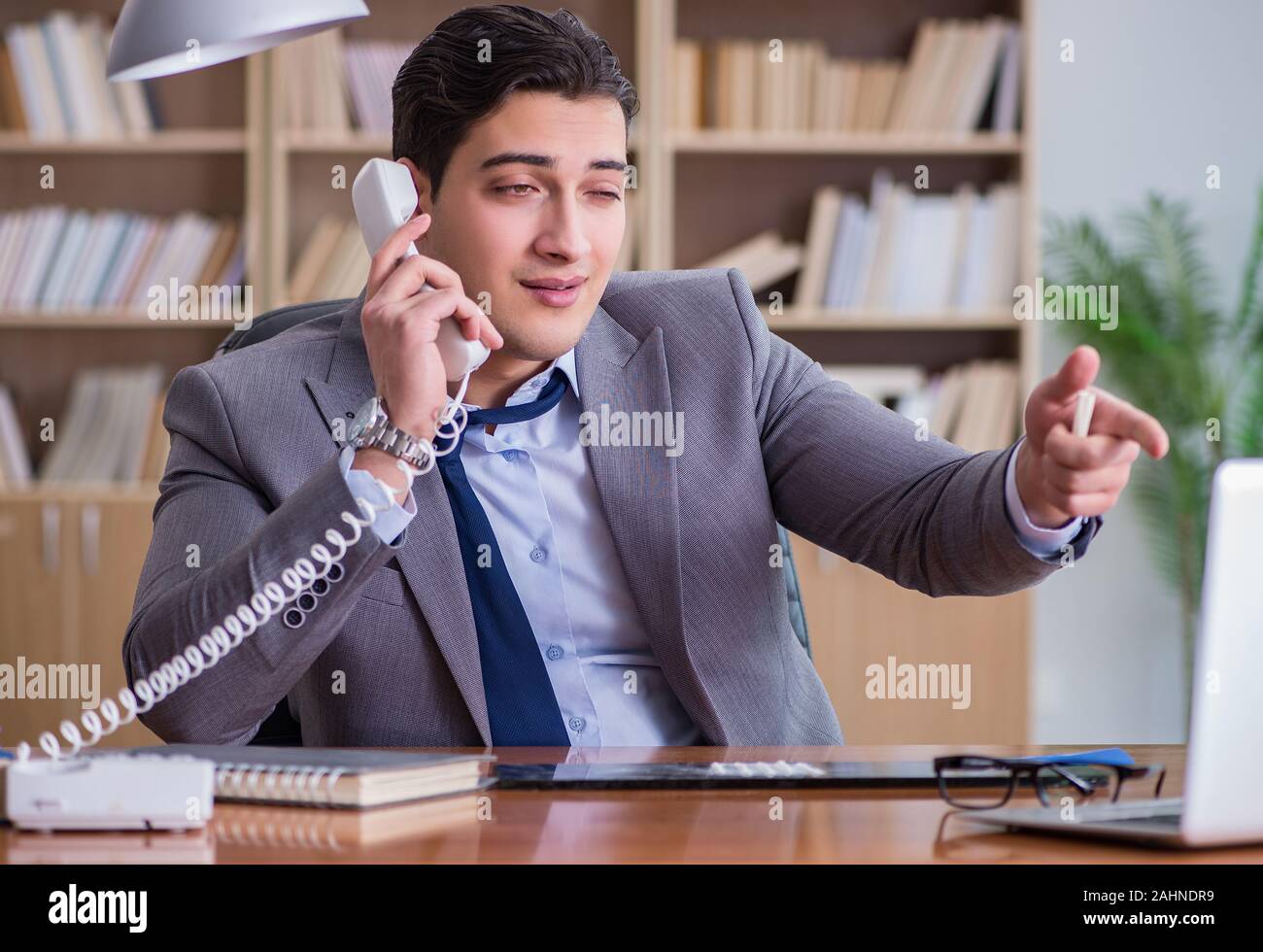 The drug addict businessman in the office Stock Photo - Alamy