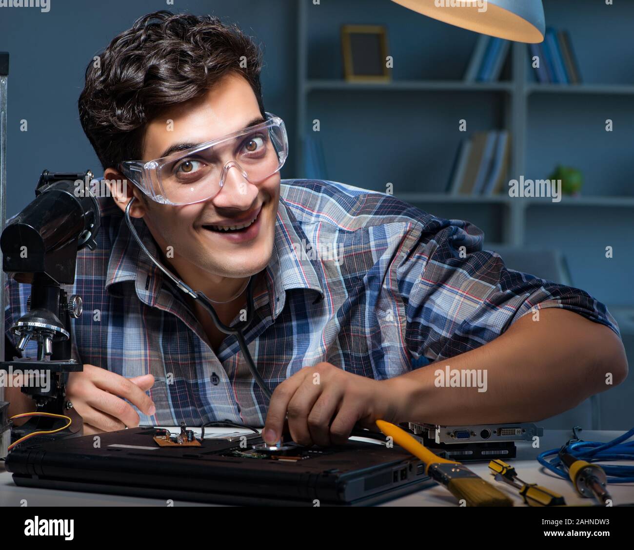 The computer repair concept with man inspecting with stethoscope Stock ...
