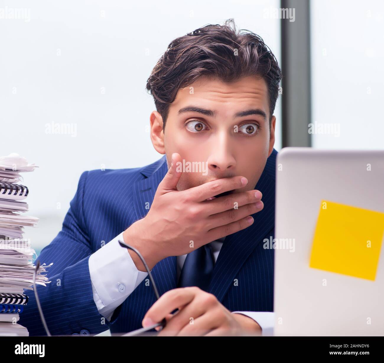 The workaholic businessman overworked with too much work in office ...