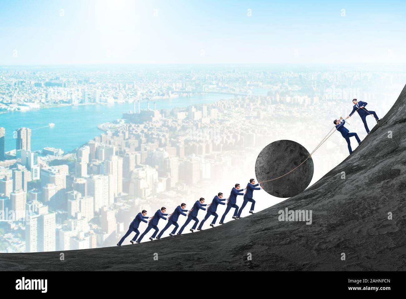 The teamwork example with business people pushing stone to top Stock ...