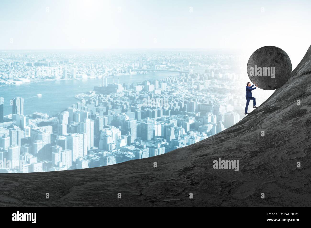The man pushing large stone to the top Stock Photo - Alamy
