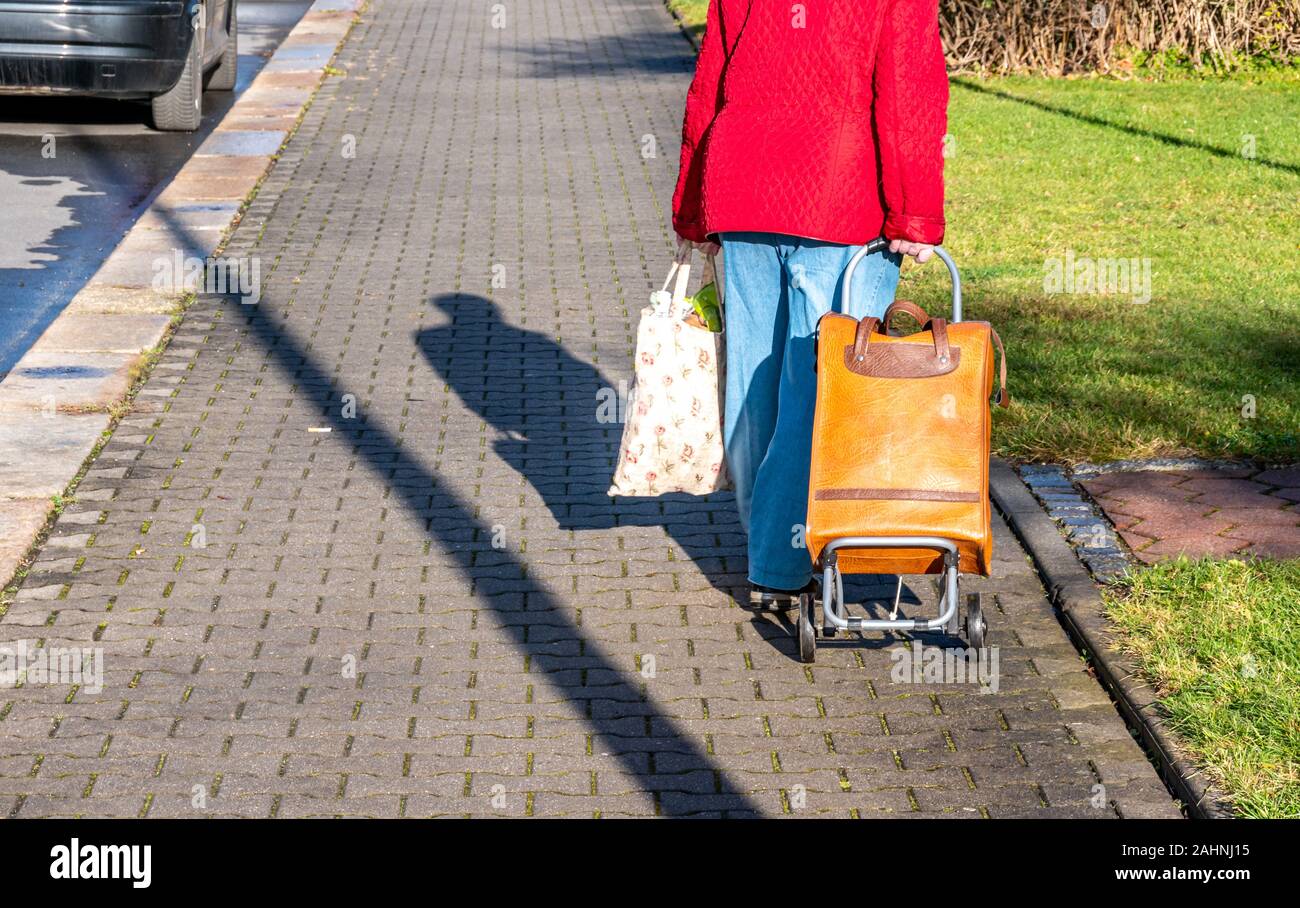 Old woman shopping trolley hi-res stock photography and images - Alamy