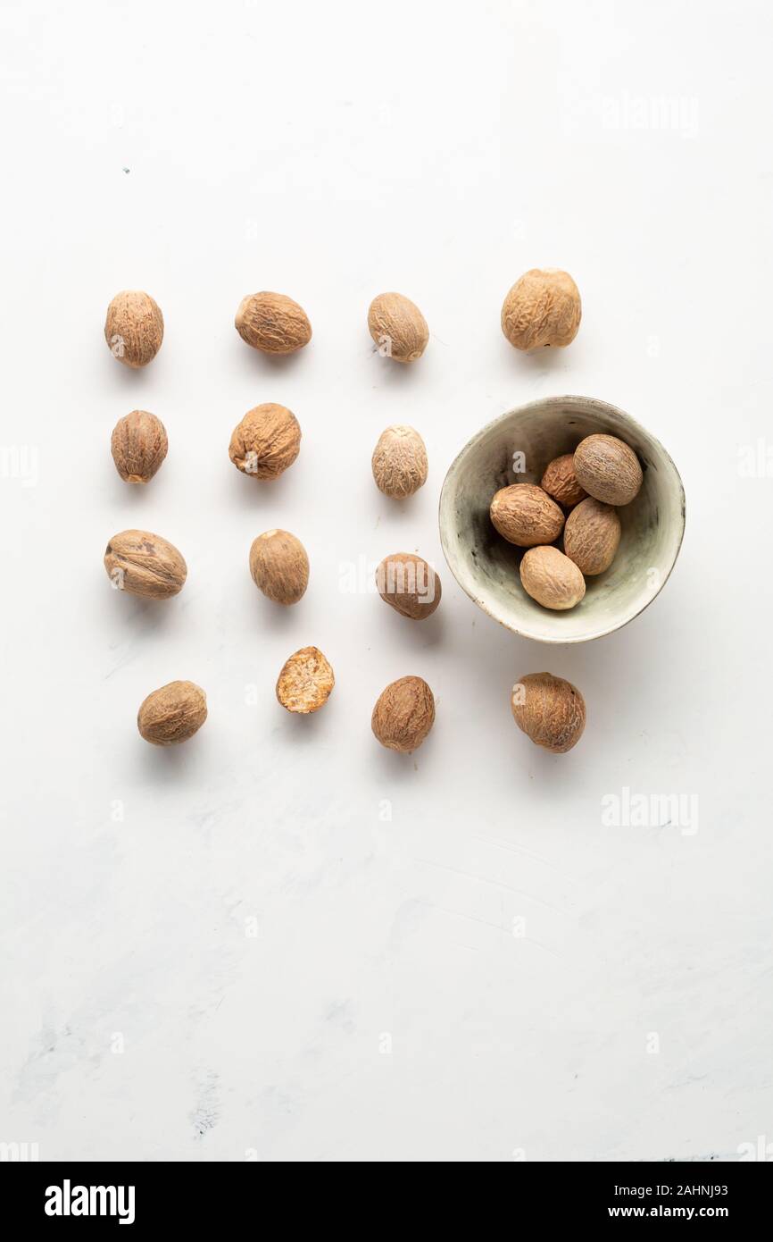 Aromatic nutmeg in bowl top view, food pattern Stock Photo - Alamy