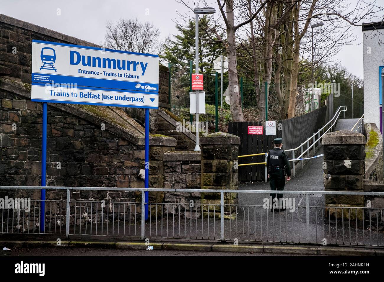 A PSNI officer attending a scene at Dunmurry railway station in west ...