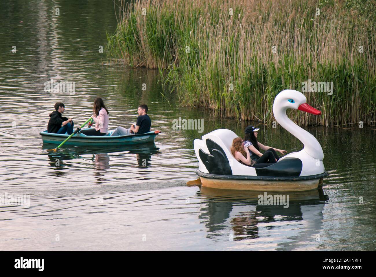 People sailing by boat on the local lake Stock Photo - Alamy