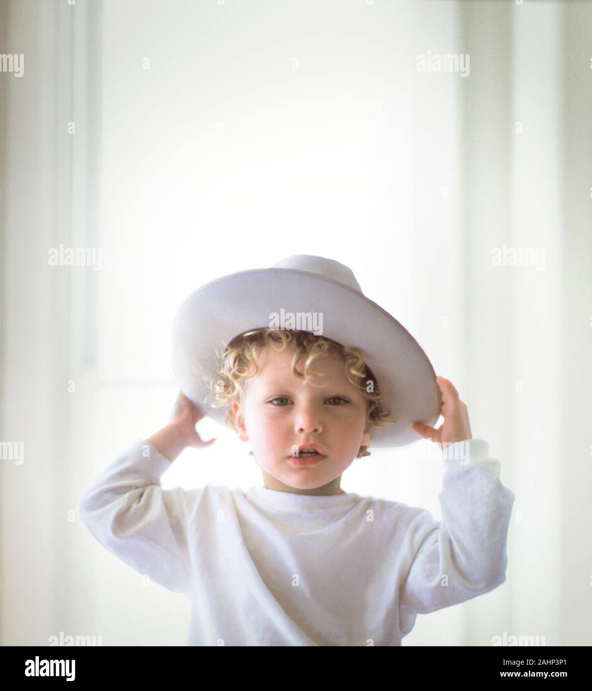 Portrait of a young boy wearing a white hat Stock Photo - Alamy