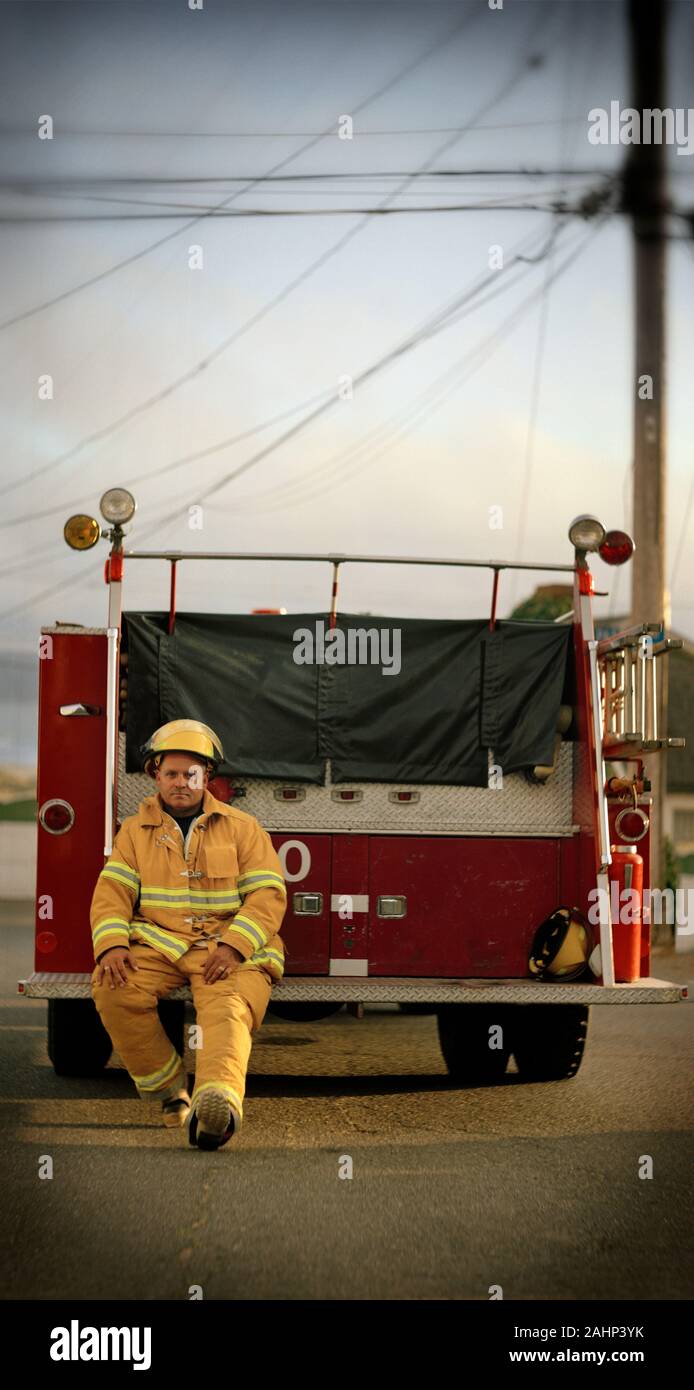 View of a firefighter sitting on a fire truck Stock Photo - Alamy