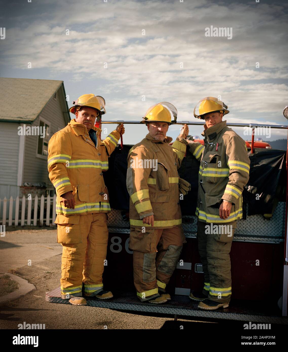 Three firemen pose for the camera Stock Photo - Alamy