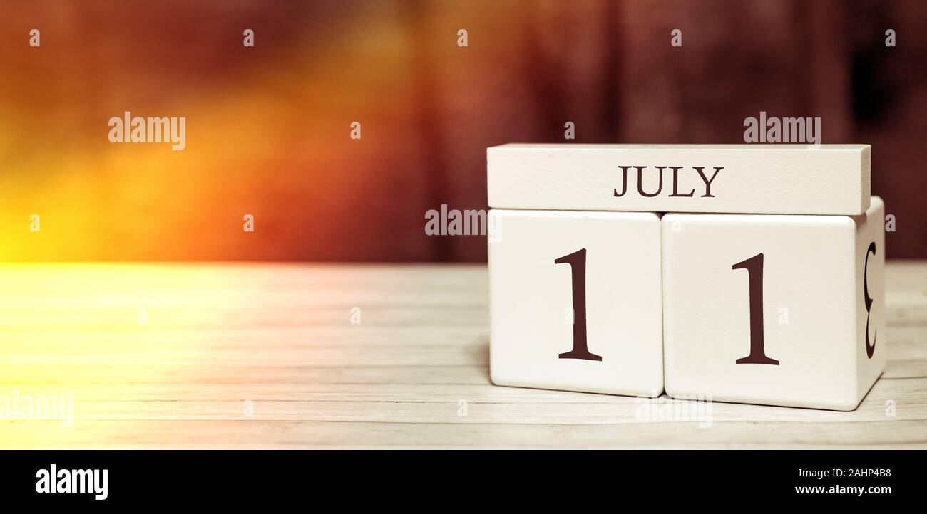 Calendar reminder event concept. Wooden cubes with numbers and month on ...