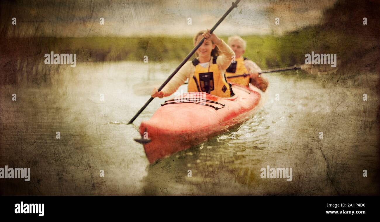 Two people rowing a boat through a lake Stock Photo - Alamy