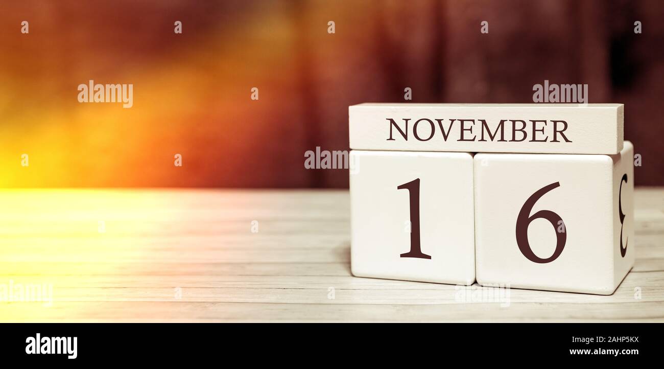 Calendar reminder event concept. Wooden cubes with numbers and month on ...