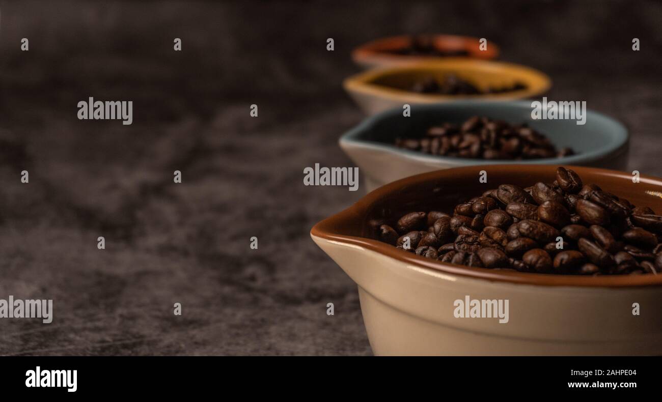 Side view of Fresh raw organic coffee beans inside many colorful ...