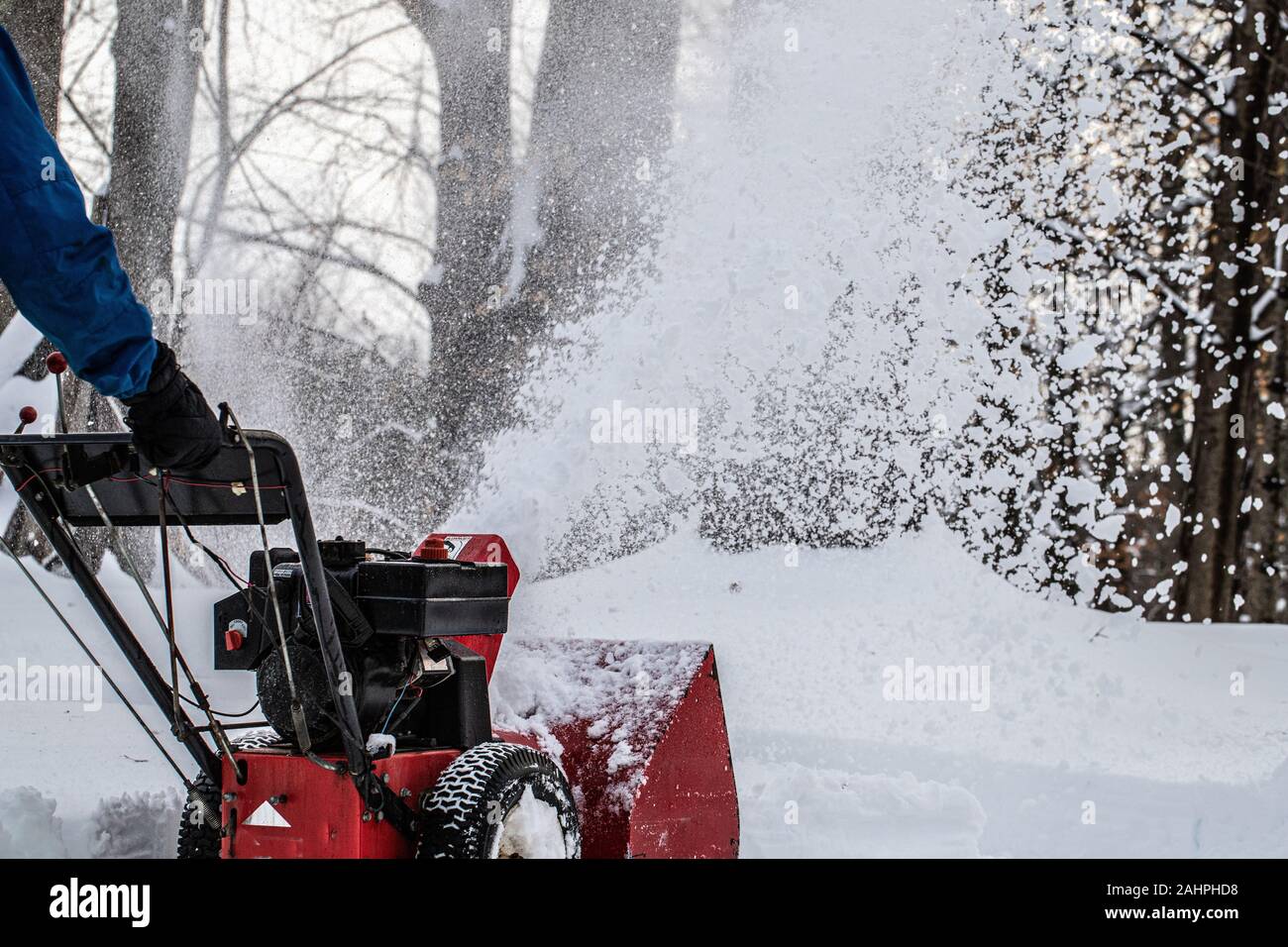 Man pushing snow blower during storm Stock Photo - Alamy