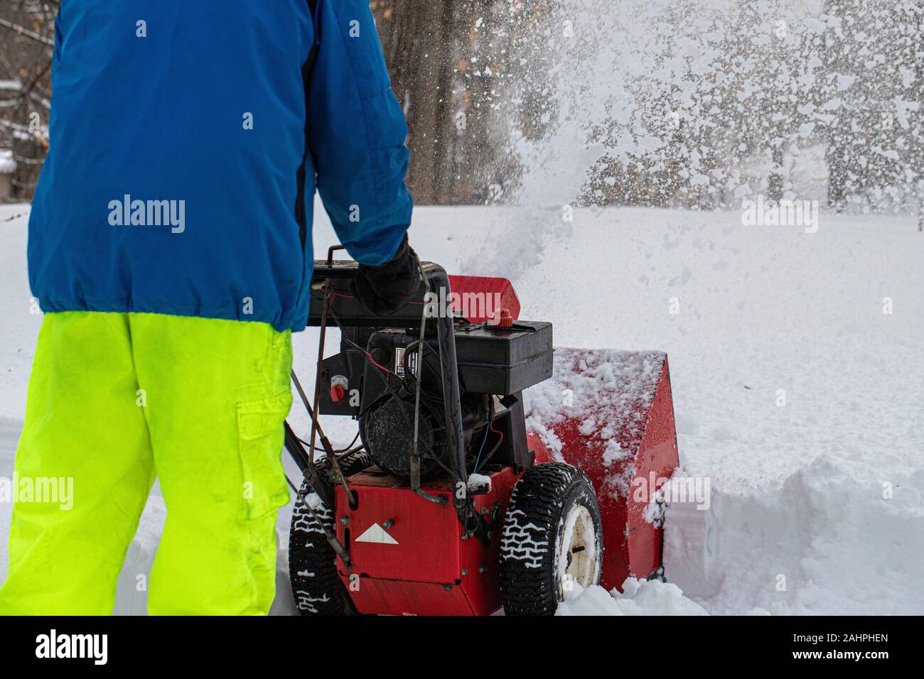 Man pushing snow blower during storm Stock Photo - Alamy