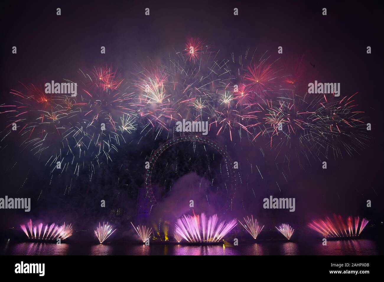 Fireworks light up the sky over the London Eye in central London during ...
