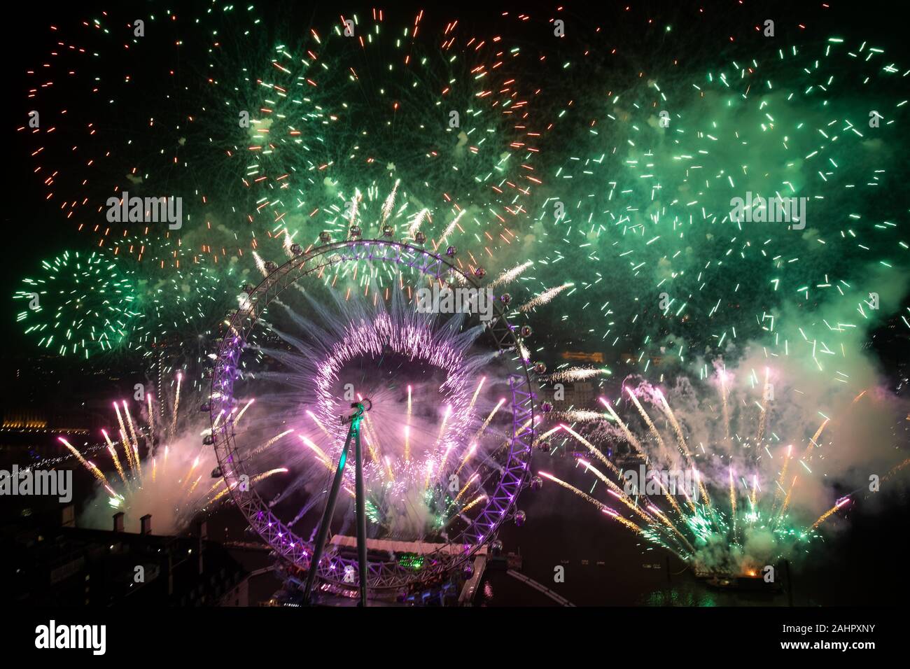 Fireworks light up the sky over the London Eye in central London during ...