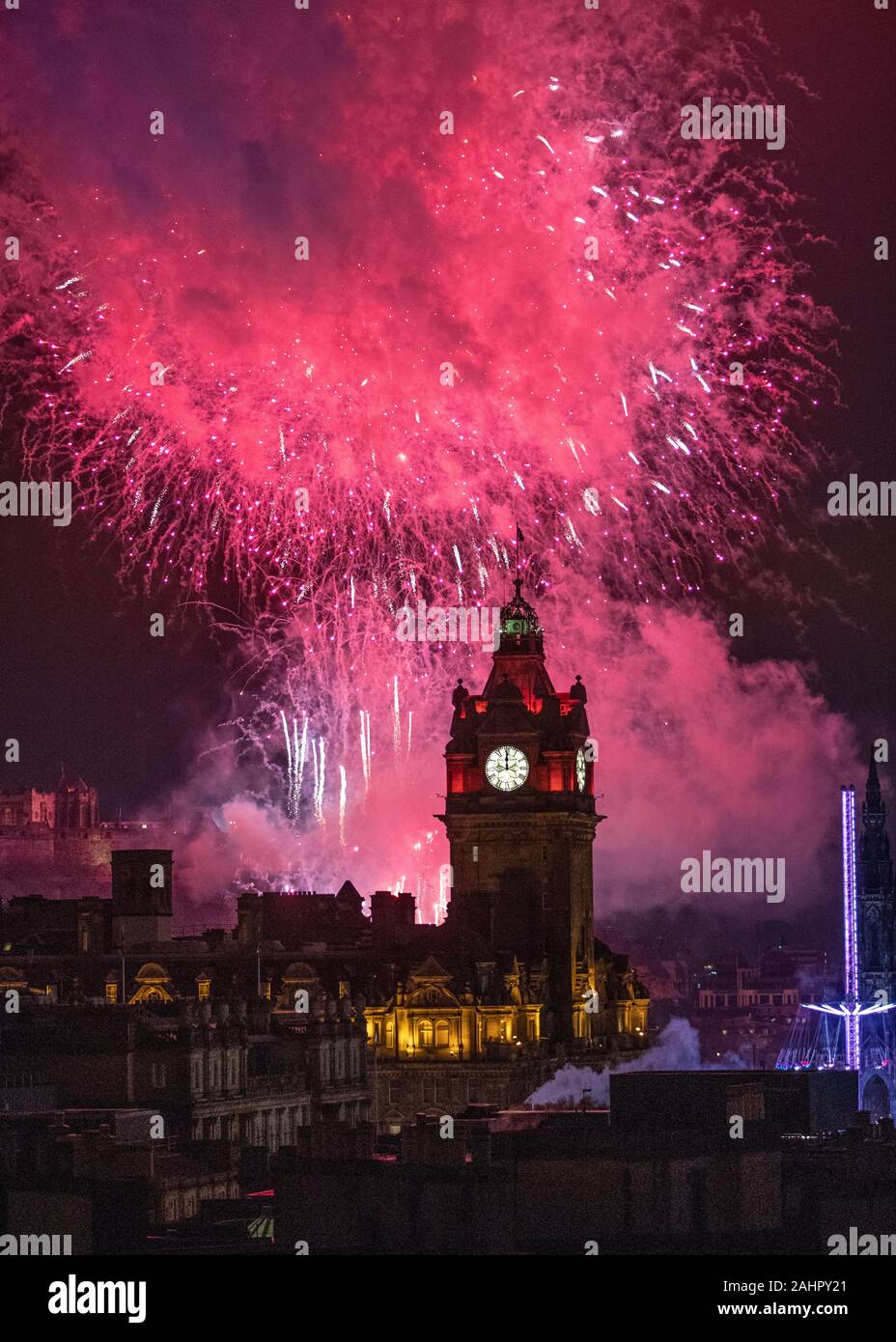 Fireworks behind the Balmoral Clock are launched from Edinburgh Castle ...