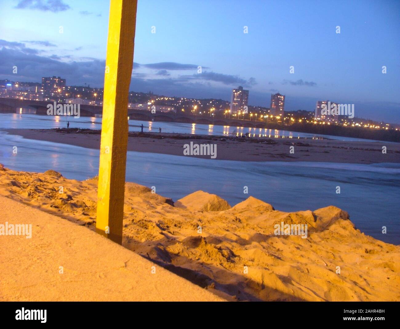 Umgeni River Mouth Estuary during a summer sunset with glow of street ...