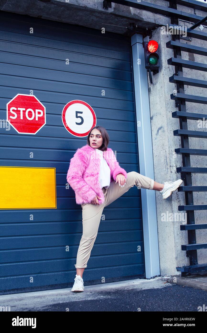 young cute girl teenager gesturing hanging around city parking and ...