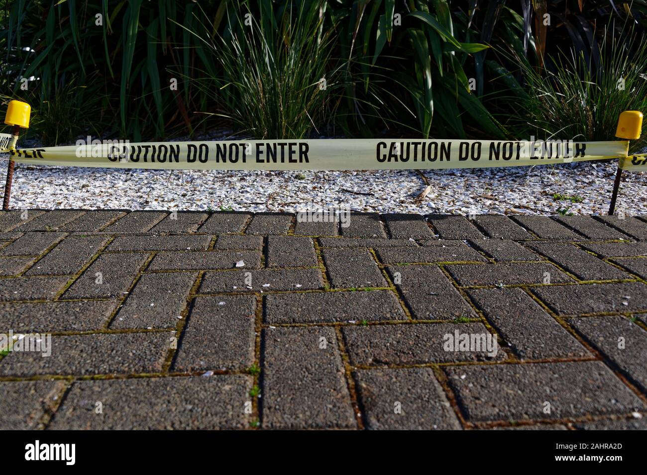 Signage tape restricts access on a path Stock Photo - Alamy