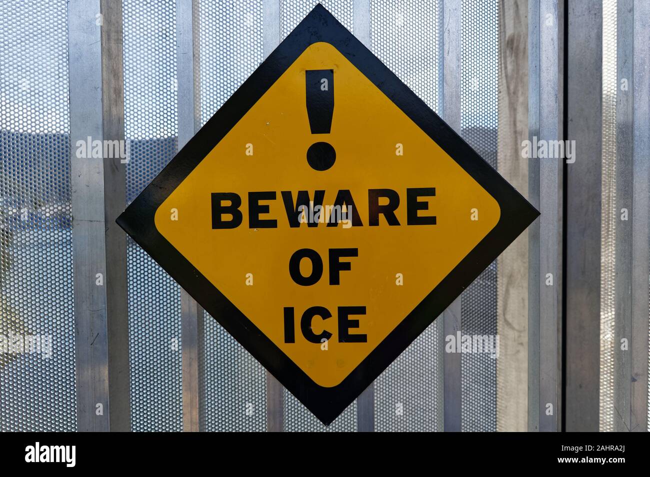 A Beware Of Ice sign warns pedestrians of the chance of slipping Stock ...