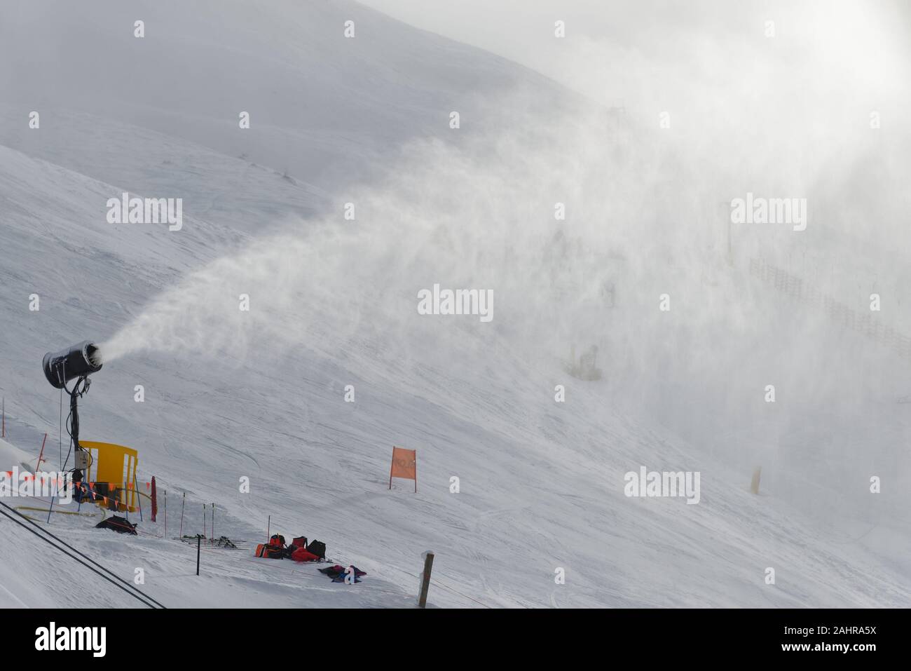 Natural snow is being topped up by a snow canon Stock Photo - Alamy