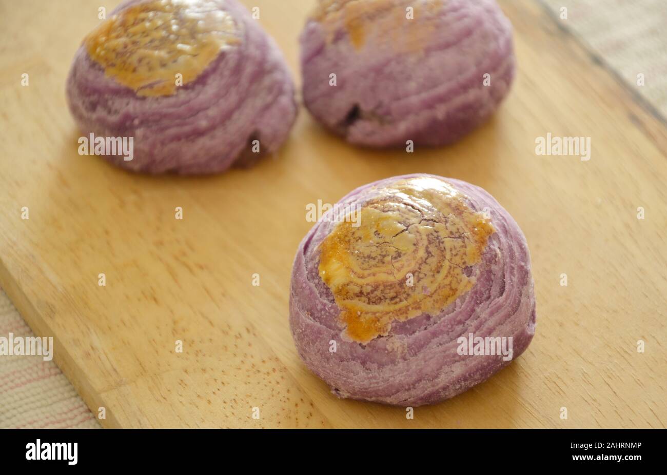 Chinese cake stuffed mush sweet taro and bean on wooden chop block ...