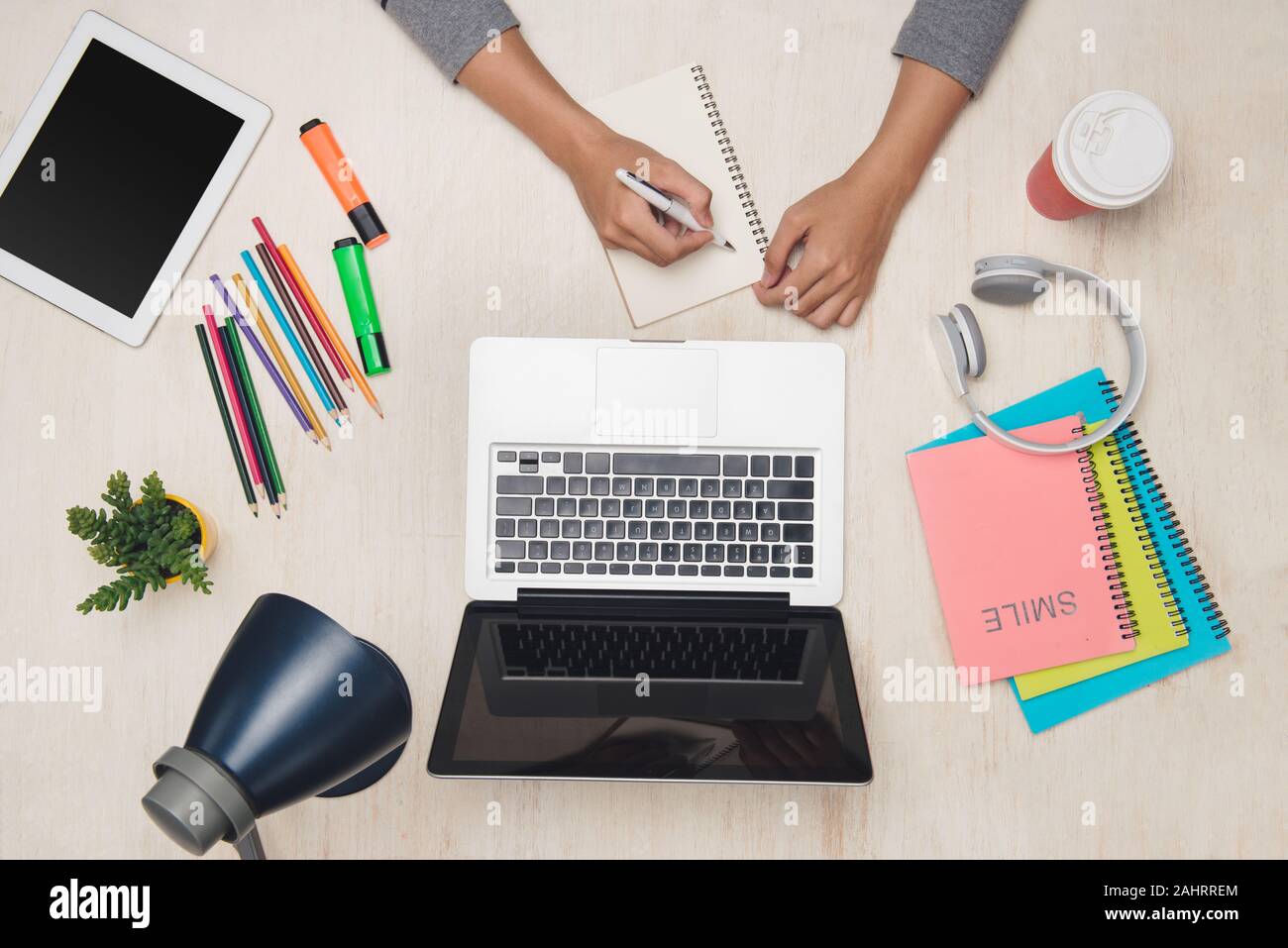 Business man is writing on blank notebook at office table. Top view ...
