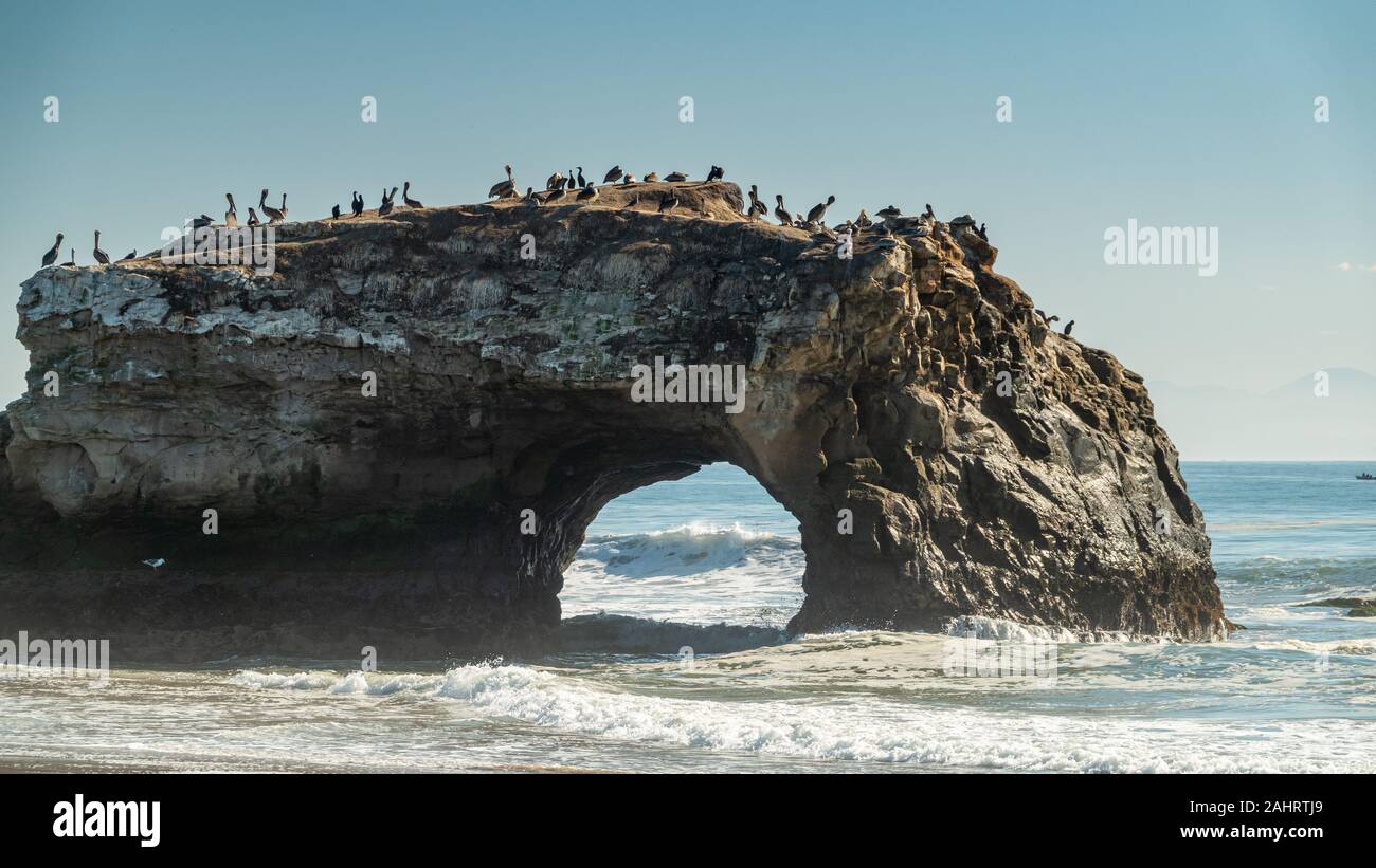 Rock forming a bridge in the ocean at Natural Bridges Santa Cruz ...