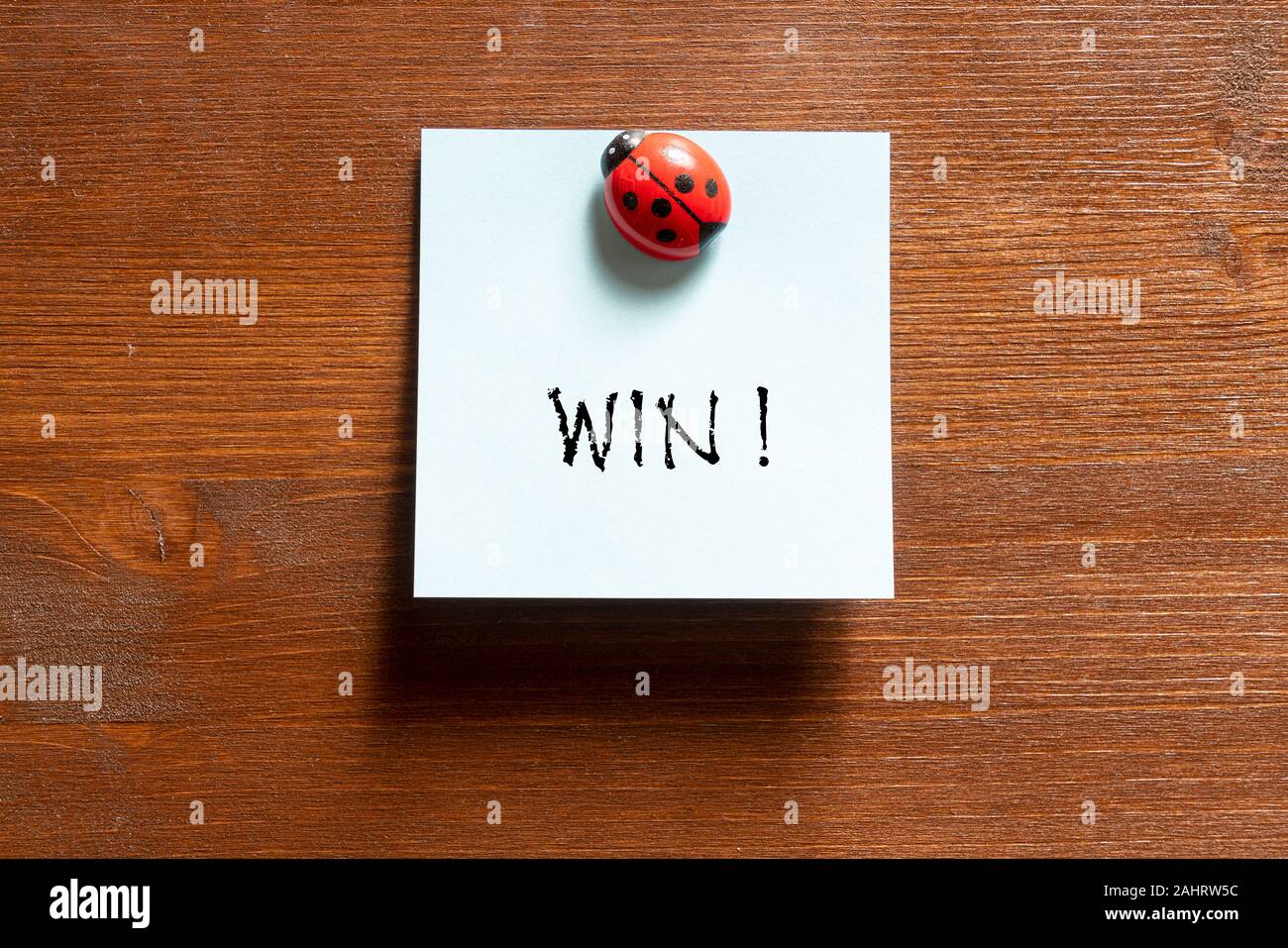 a colored memo sheet with writing win Stock Photo - Alamy