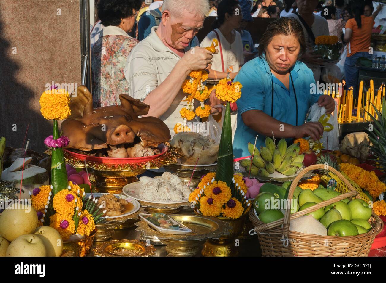 A pig's head left by worshippers as sacrificial gift at a shrine ...