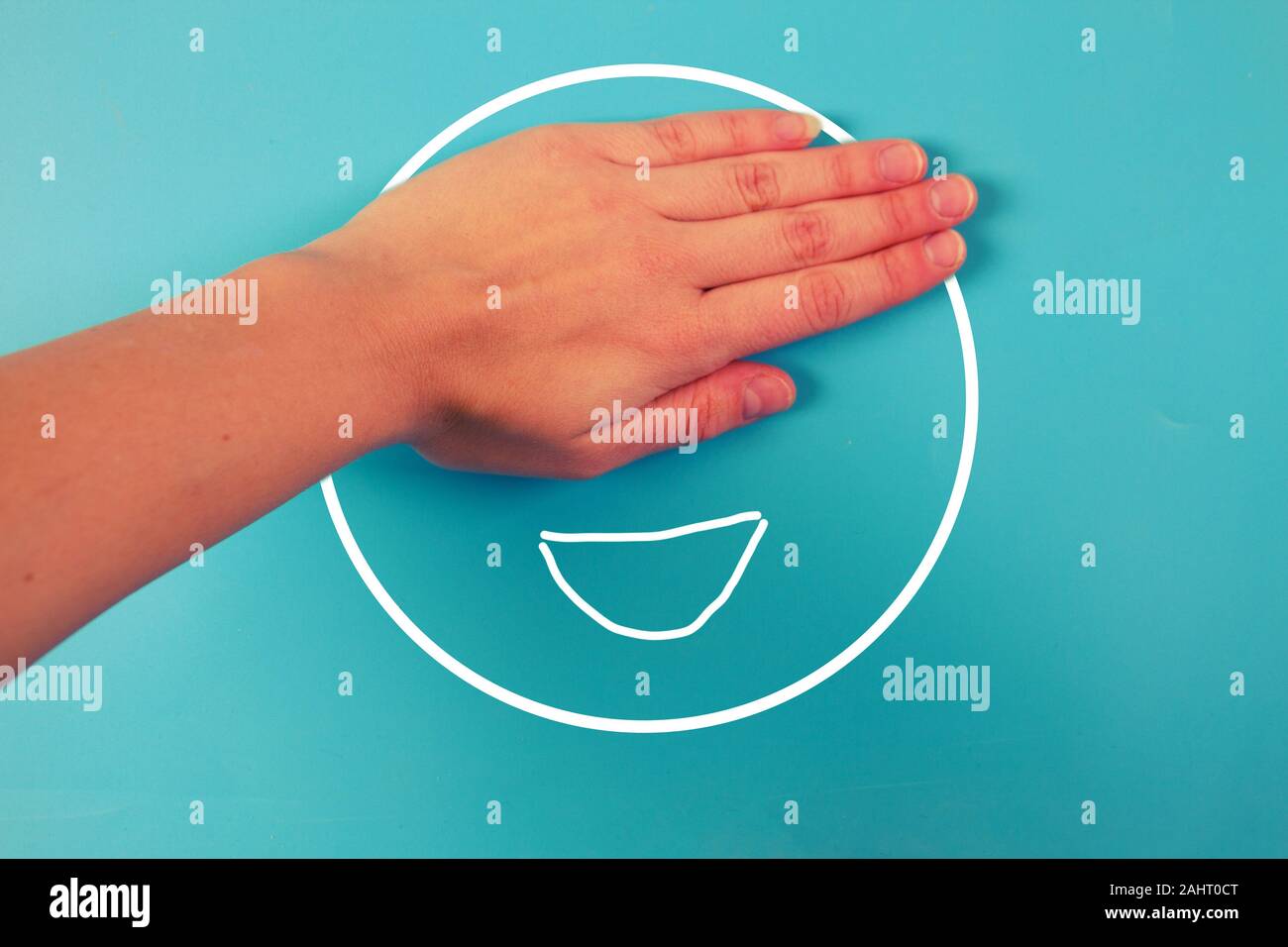 Surprise concept image. Hand close eyes of a smiley Stock Photo - Alamy