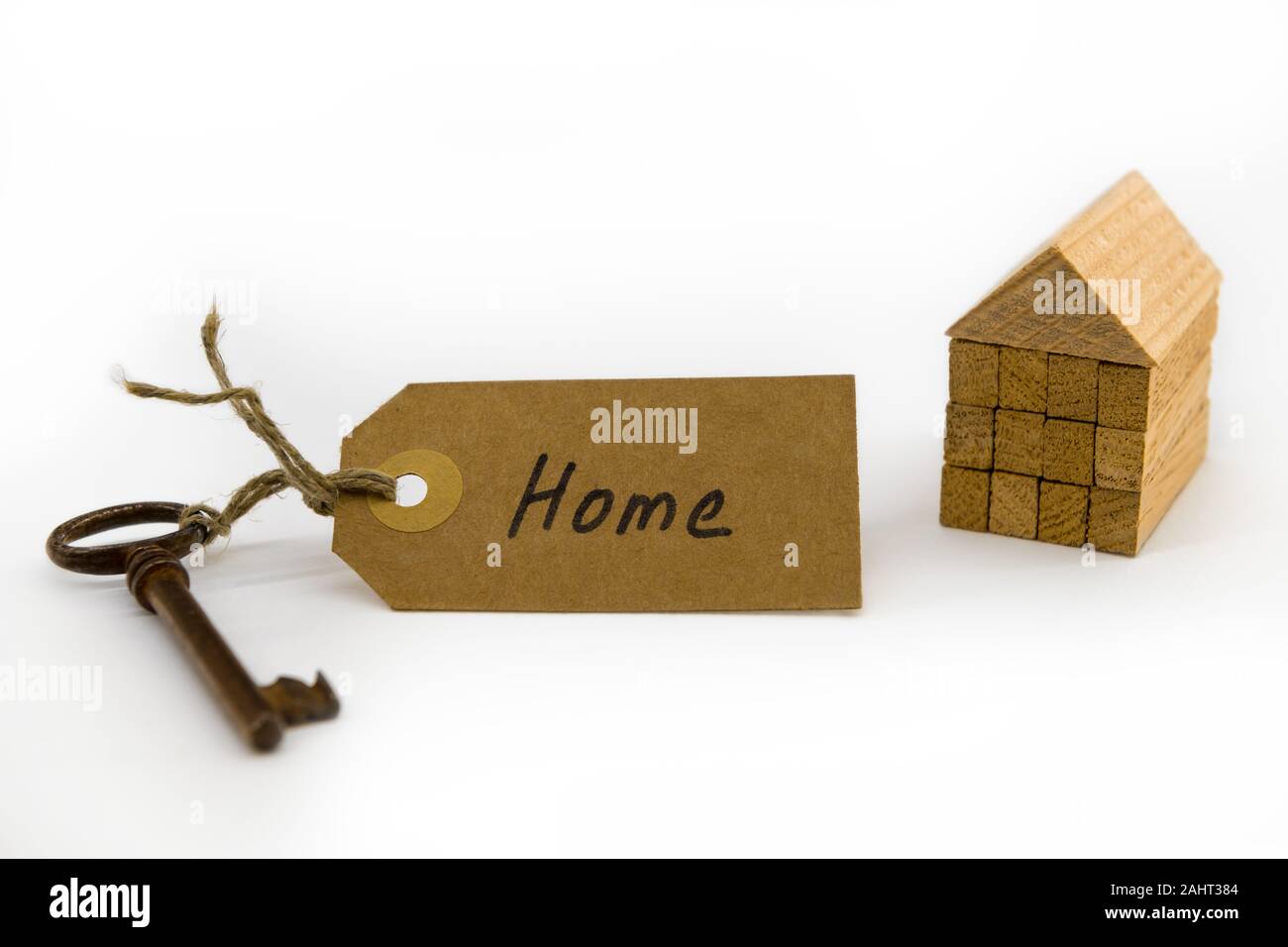 Old key with label and wooden model house Stock Photo - Alamy