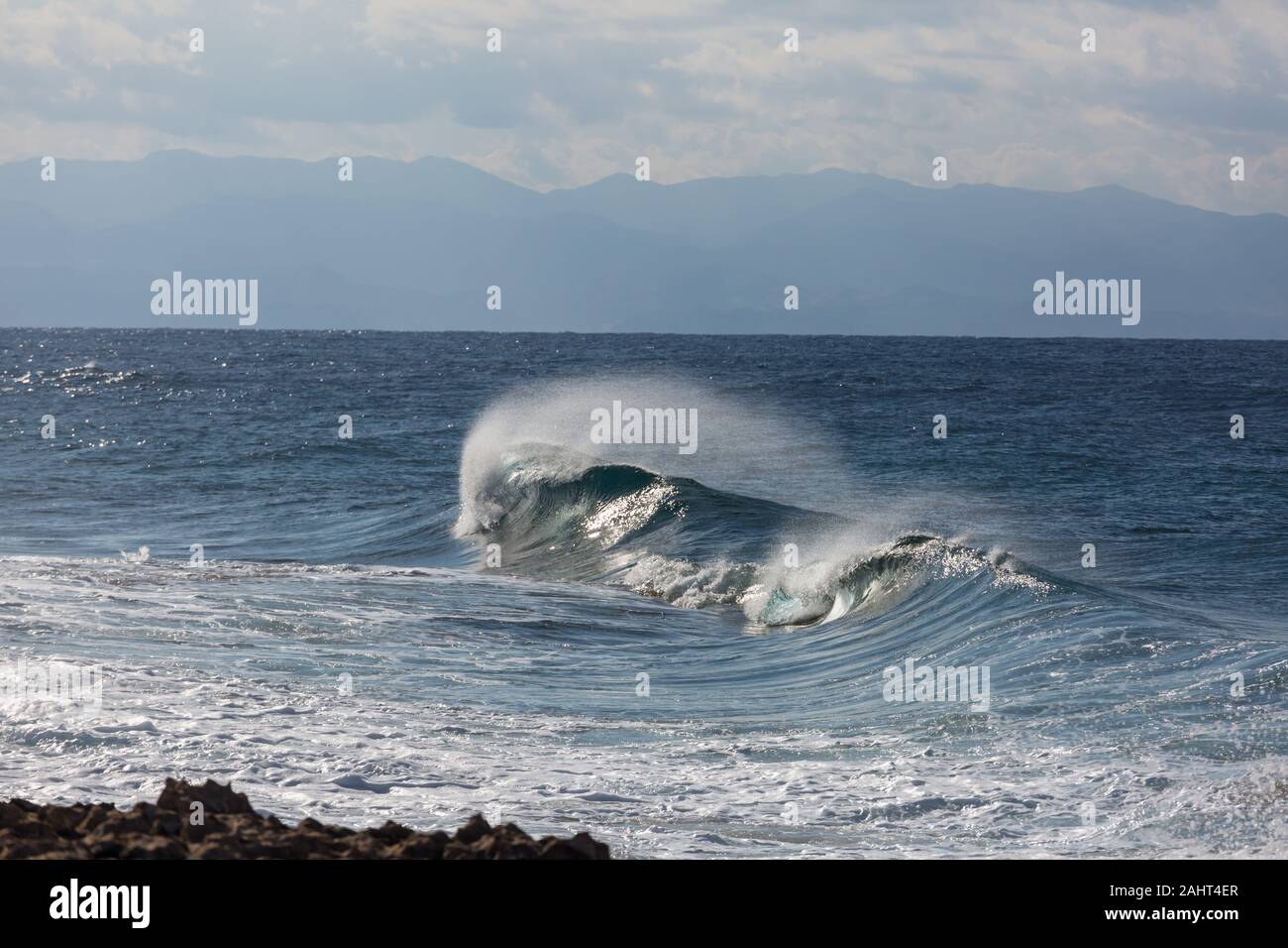 Man standing against the sea on a pier with big wave beating with ...
