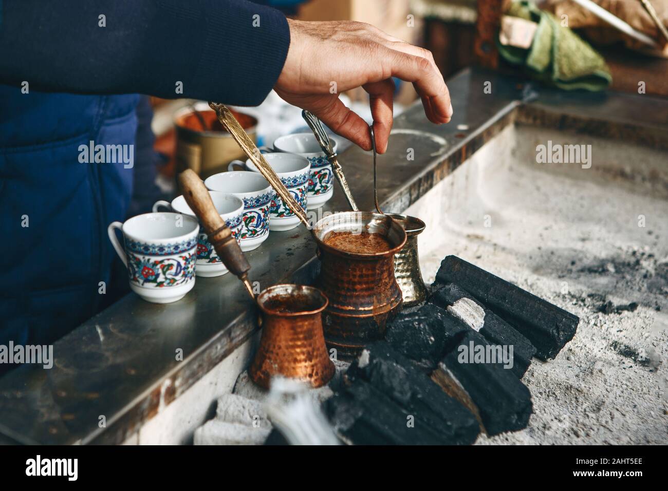 Cooking fresh aromatic traditional Turkish coffee on charcoal ...
