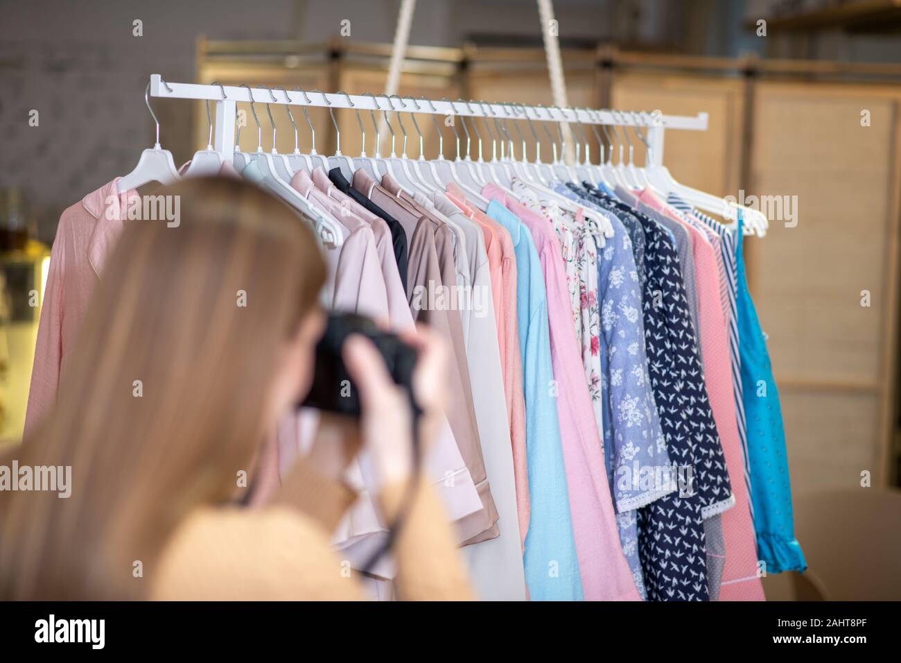 Woman taking pictures of clothes for online store Stock Photo - Alamy