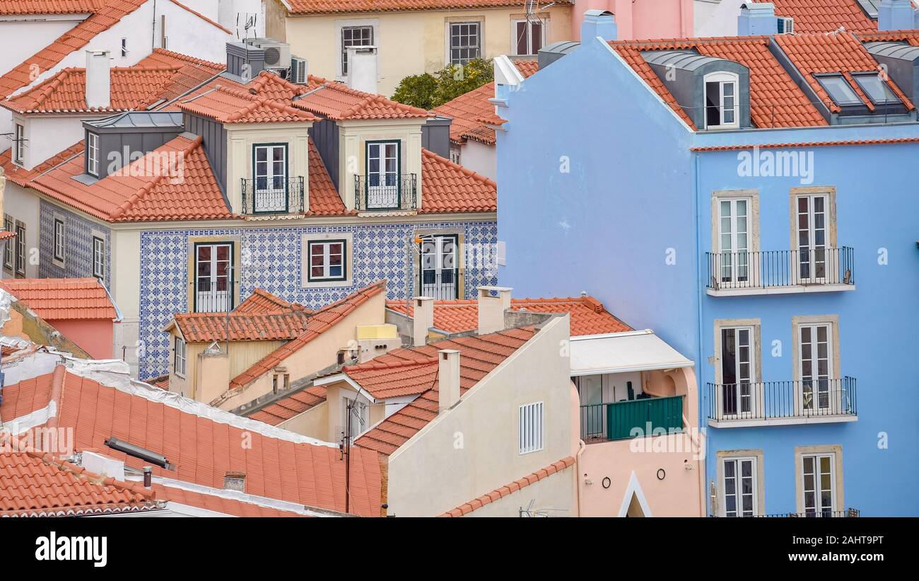 Colorful walls of the buildings of Lisbon, with orange roofs. Tourism ...