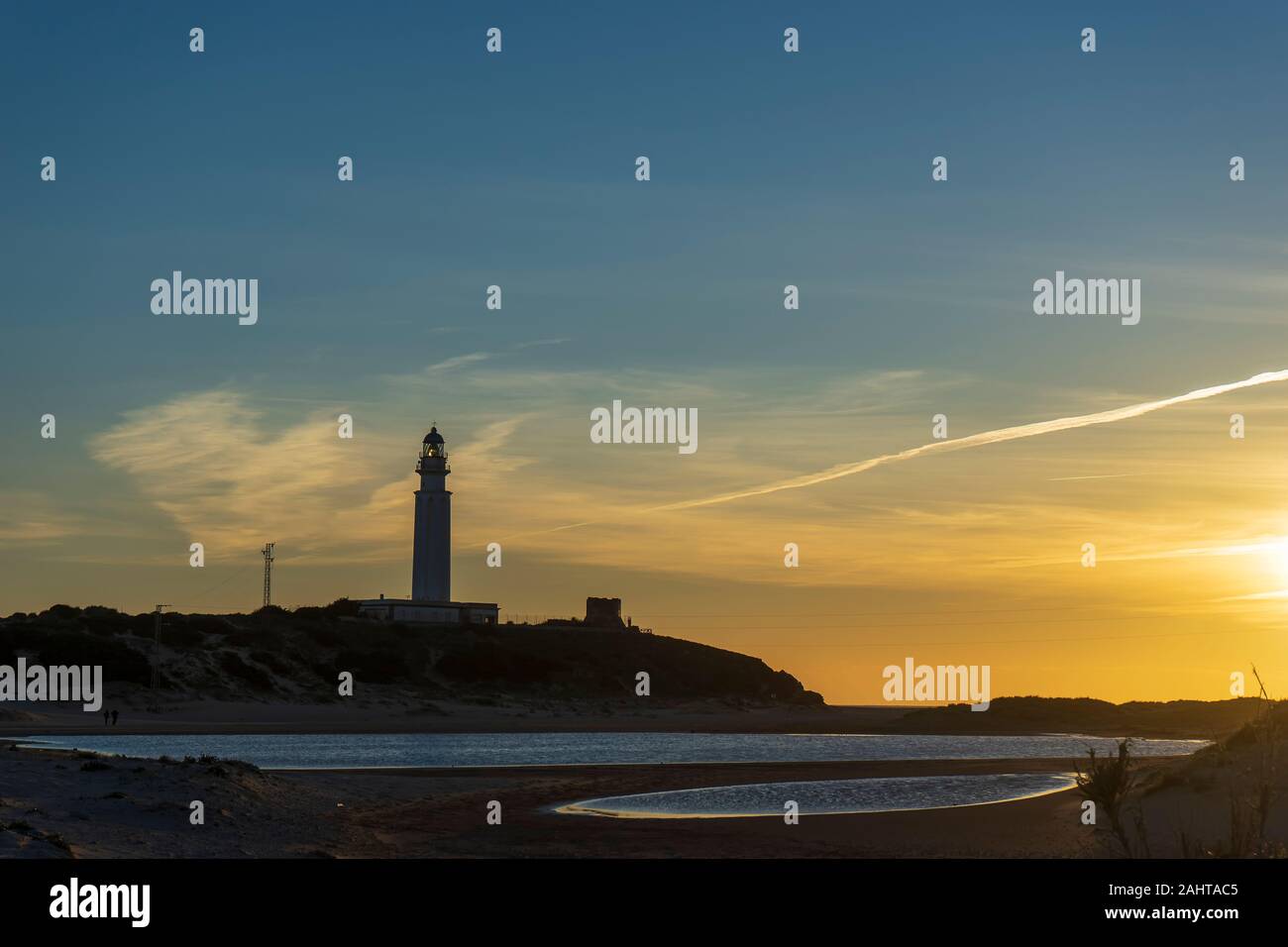 Trafalgar lighthouse on the coast of Cadiz at sunset Stock Photo - Alamy