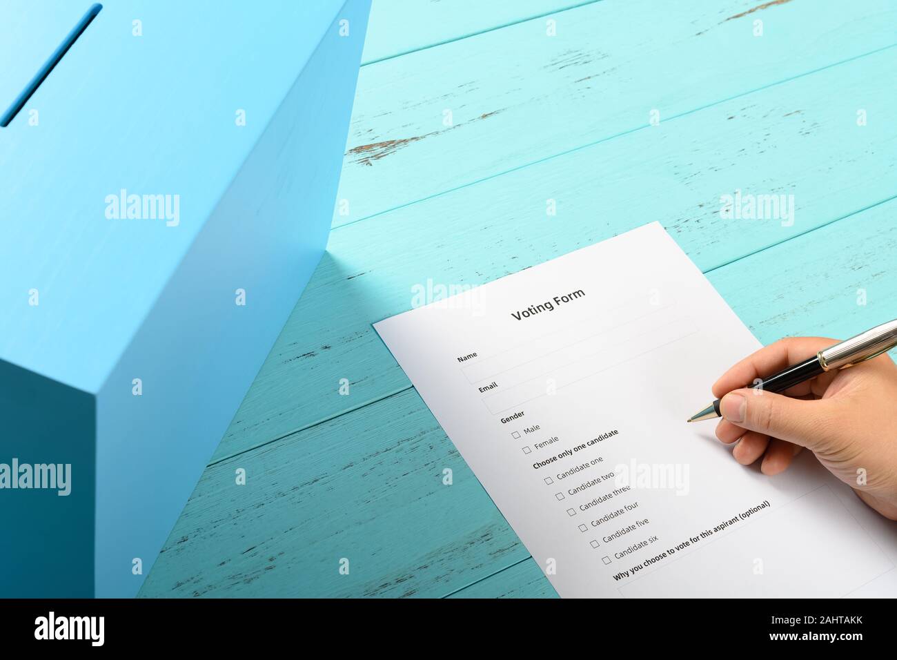 man about to fill a voting form with a vote box nearby Stock Photo - Alamy
